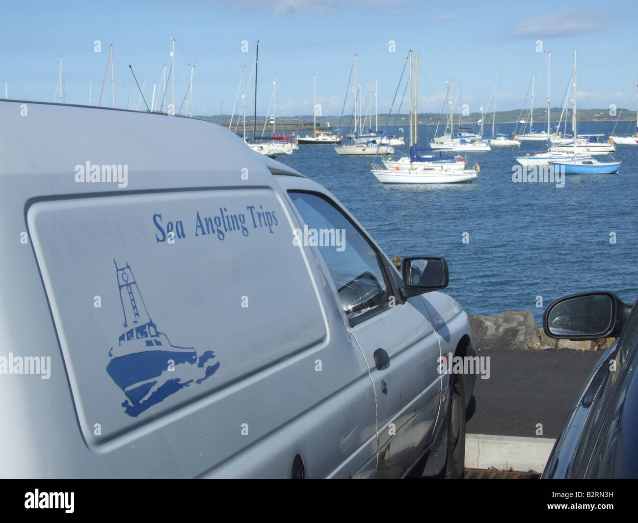 sea angling trips written on van in holyhead harbour, wales Stock Photo ...