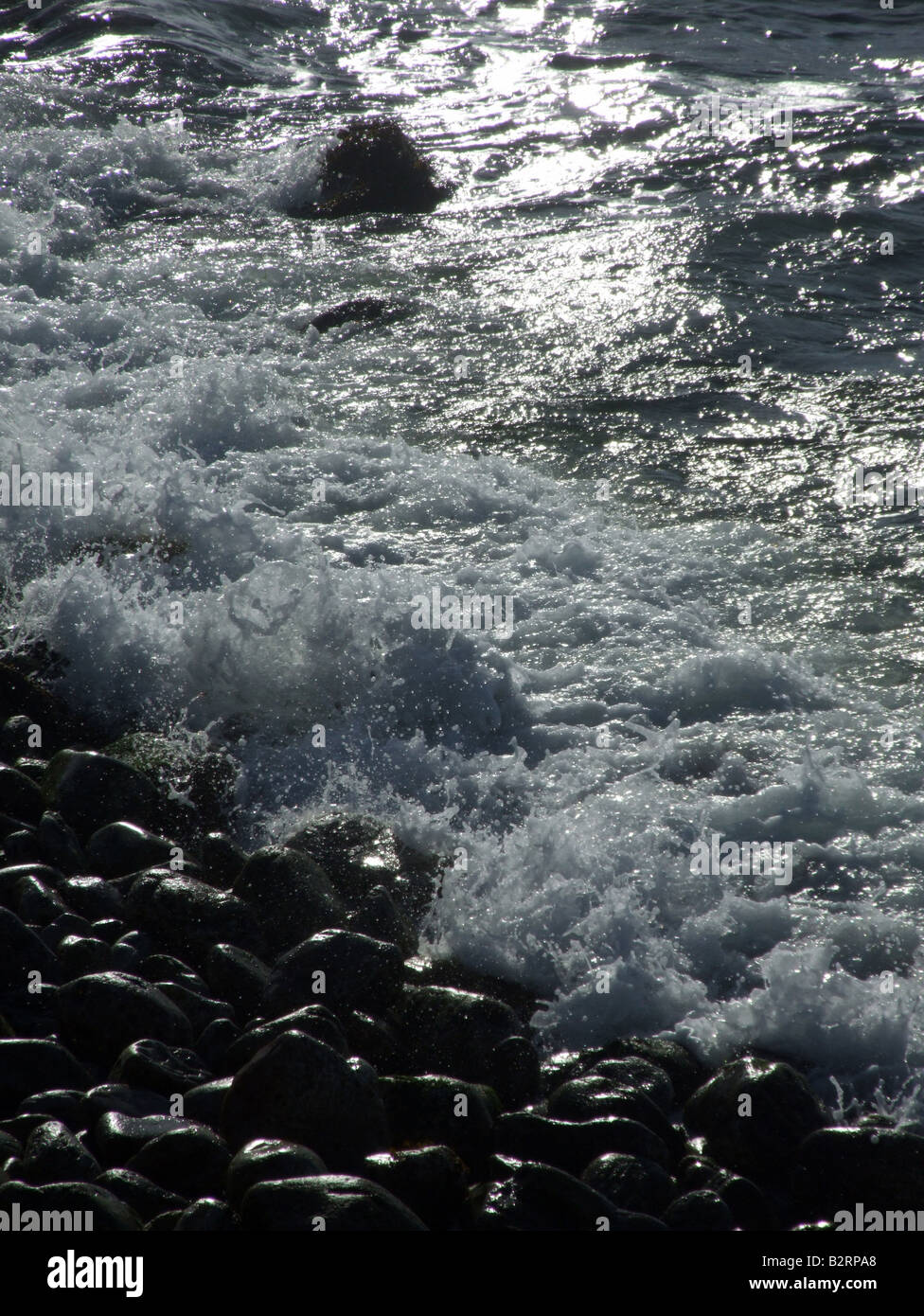 waves breaking onto rocks sea shore coast Stock Photo - Alamy