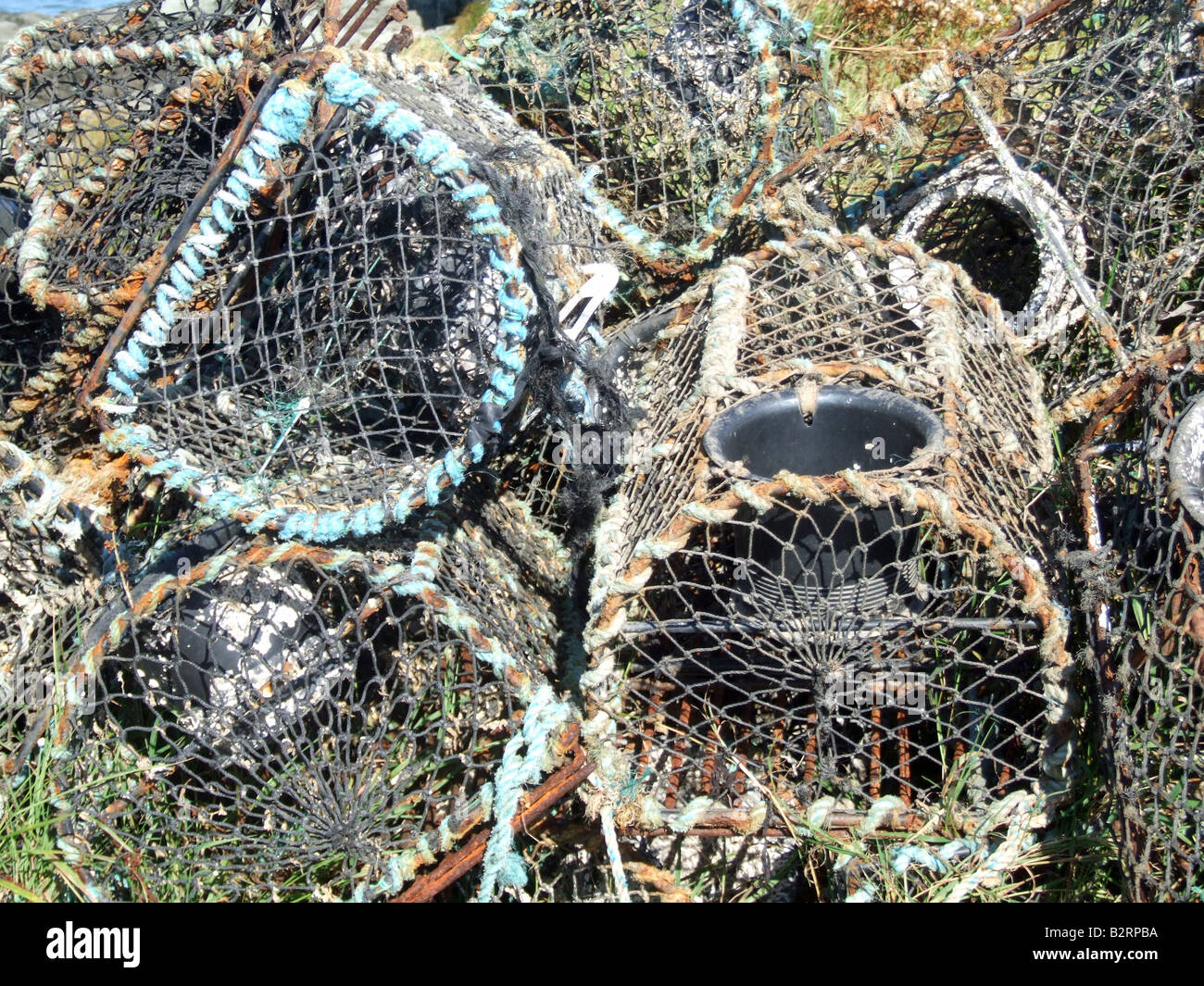 pile of fishing lobster pot traps in port by sea Stock Photo - Alamy