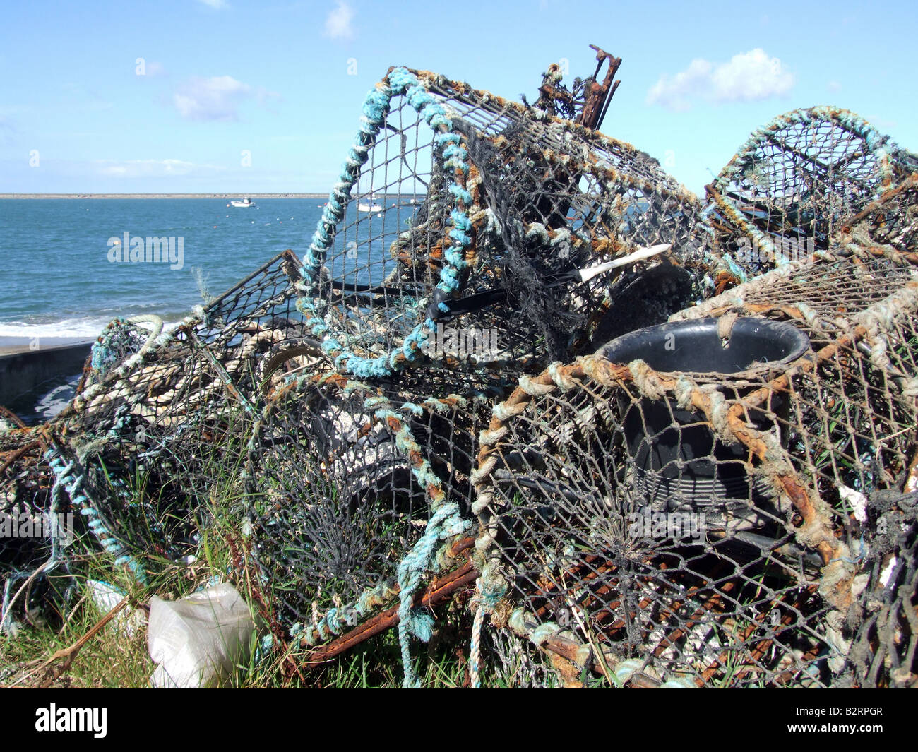 pile of fishing lobster pot traps in port by sea Stock Photo - Alamy