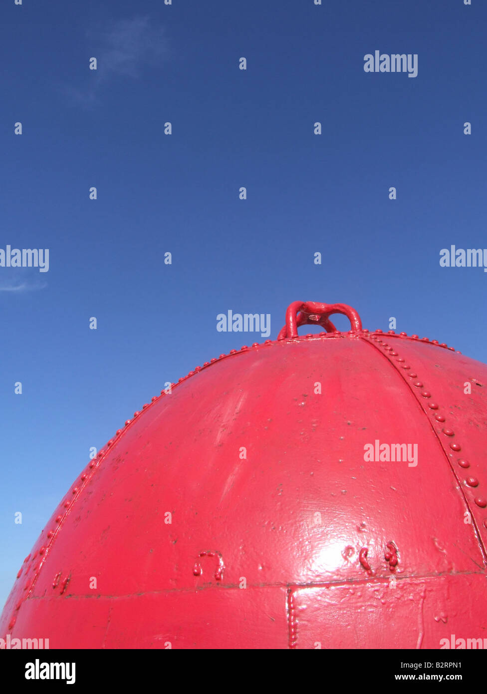 detail of red metal steel buoy and blue sky in sun Stock Photo - Alamy