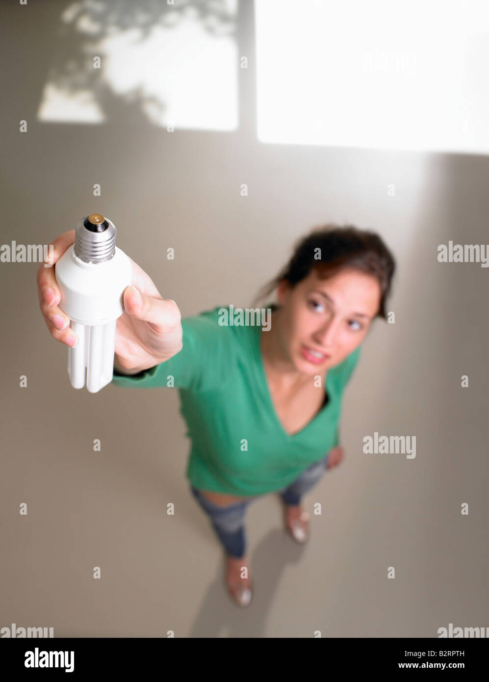 Woman fixing a light bulb Stock Photo - Alamy