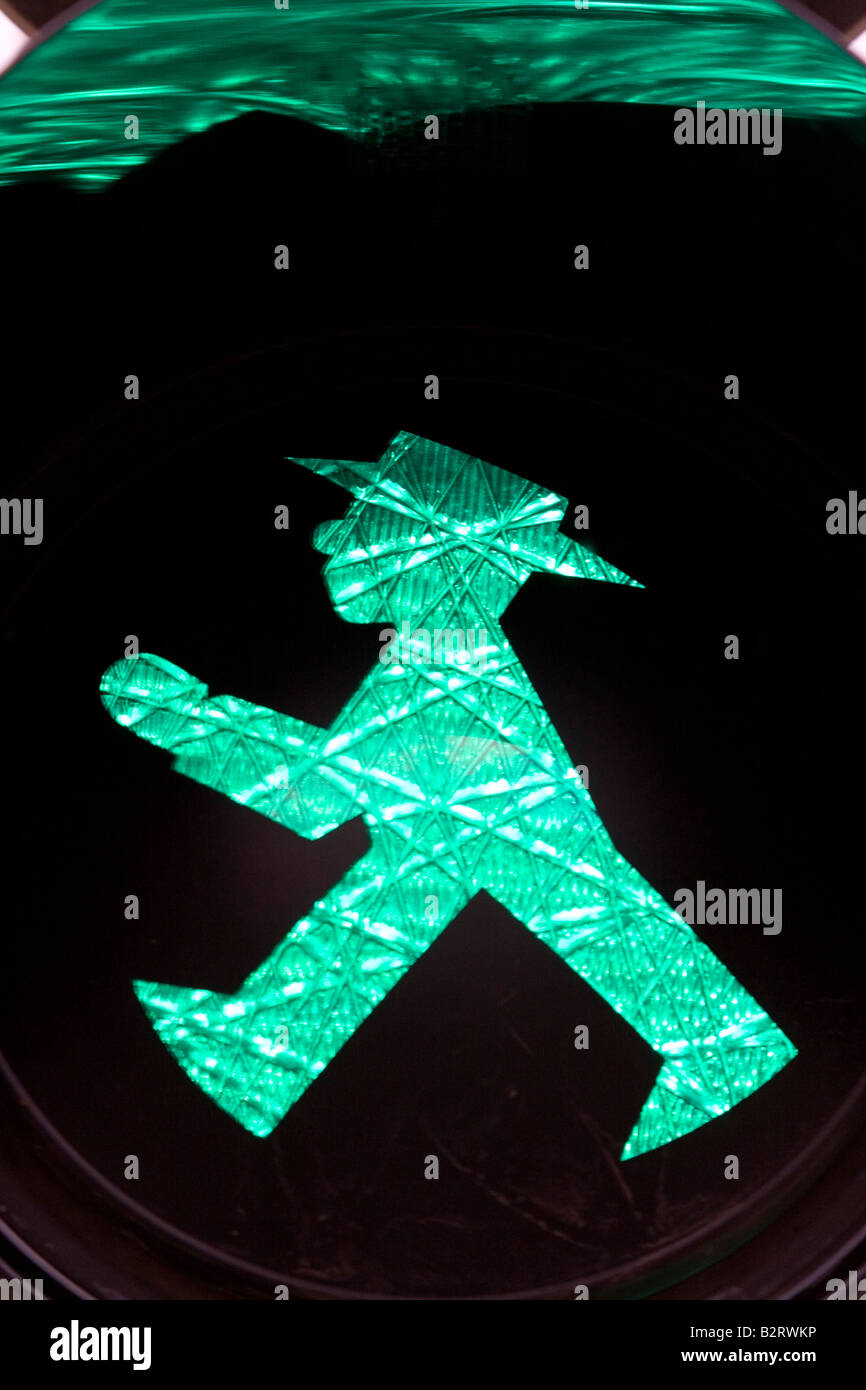 A green pedestrian traffic light in Dresden, Germany. The lights are ...