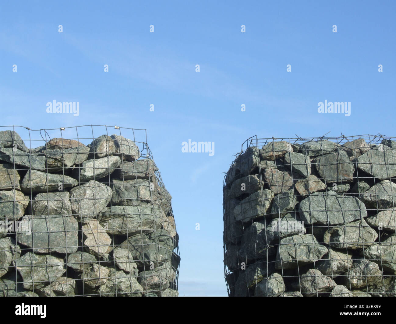 pile of rocks supported in a steel wire mesh Stock Photo - Alamy