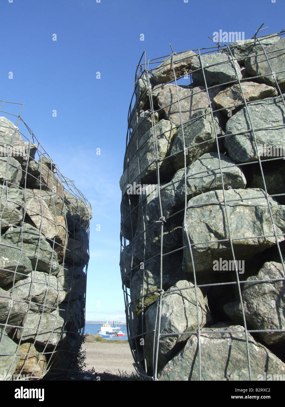 pile of rocks supported in a steel wire mesh Stock Photo - Alamy
