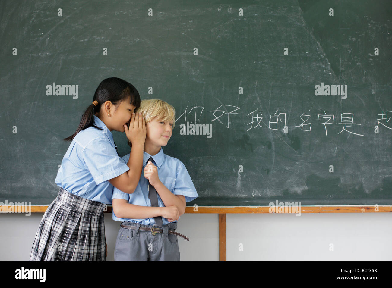 Instructing two standing children hi-res stock photography and images ...