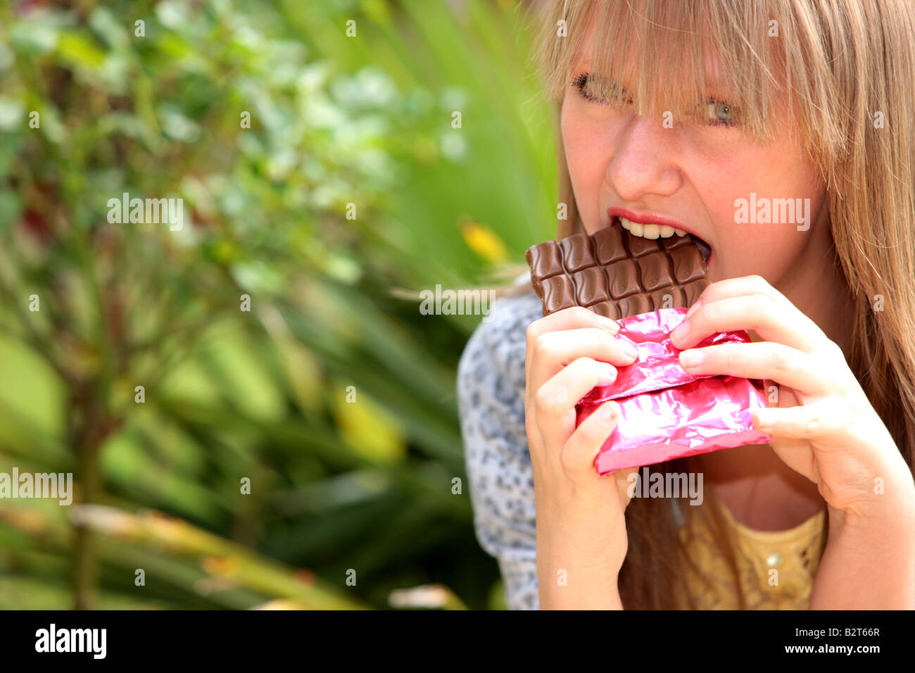 Teenage Girl Eating Bar of Chocolate Model Released Stock Photo - Alamy