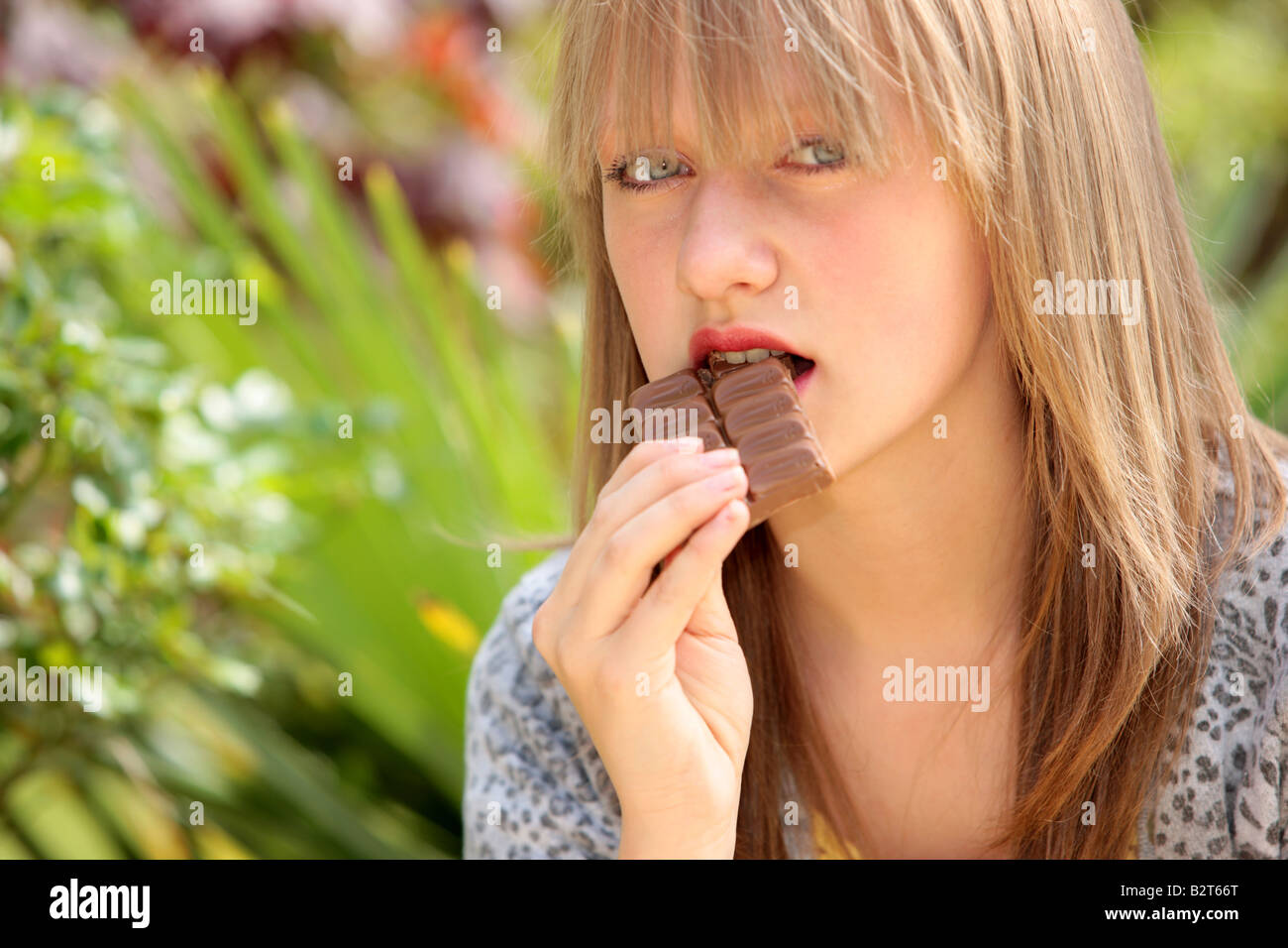 Teenage Girl Eating Bar of Chocolate Model Released Stock Photo - Alamy