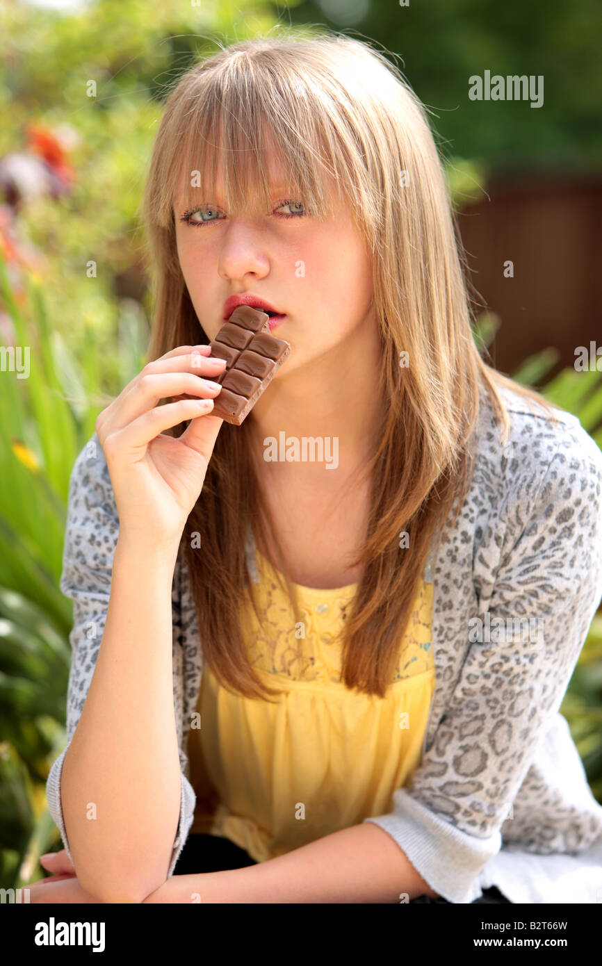 Teenage Girl Eating Bar of Chocolate Model Released Stock Photo - Alamy
