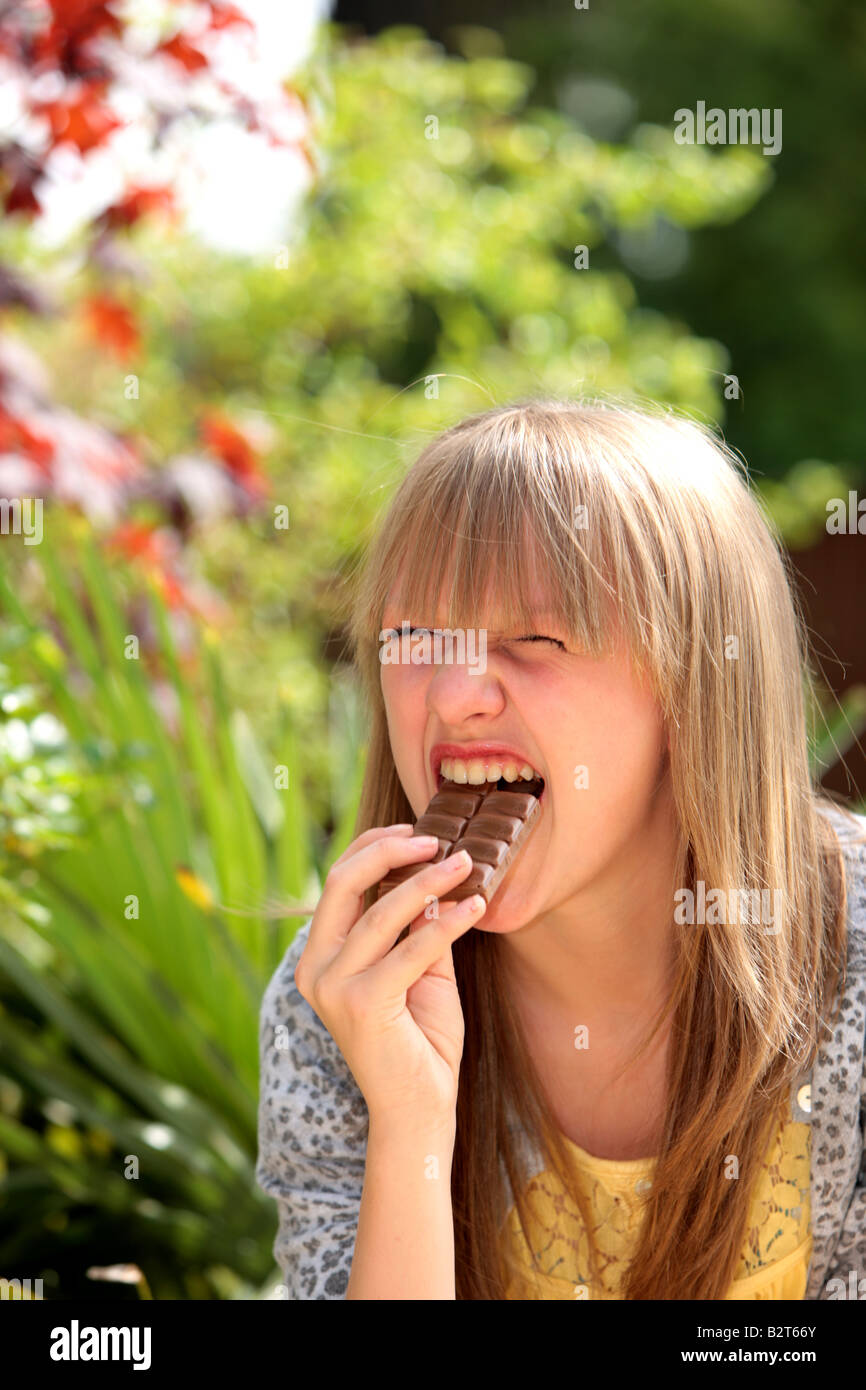 Teenage Girl Eating Bar of Chocolate Model Released Stock Photo - Alamy