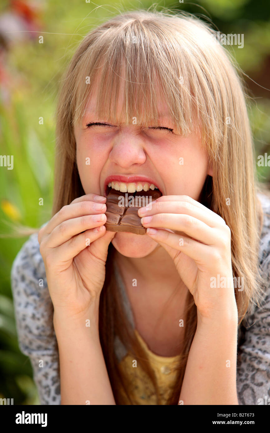 Teenage Girl Eating Bar of Chocolate Model Released Stock Photo - Alamy