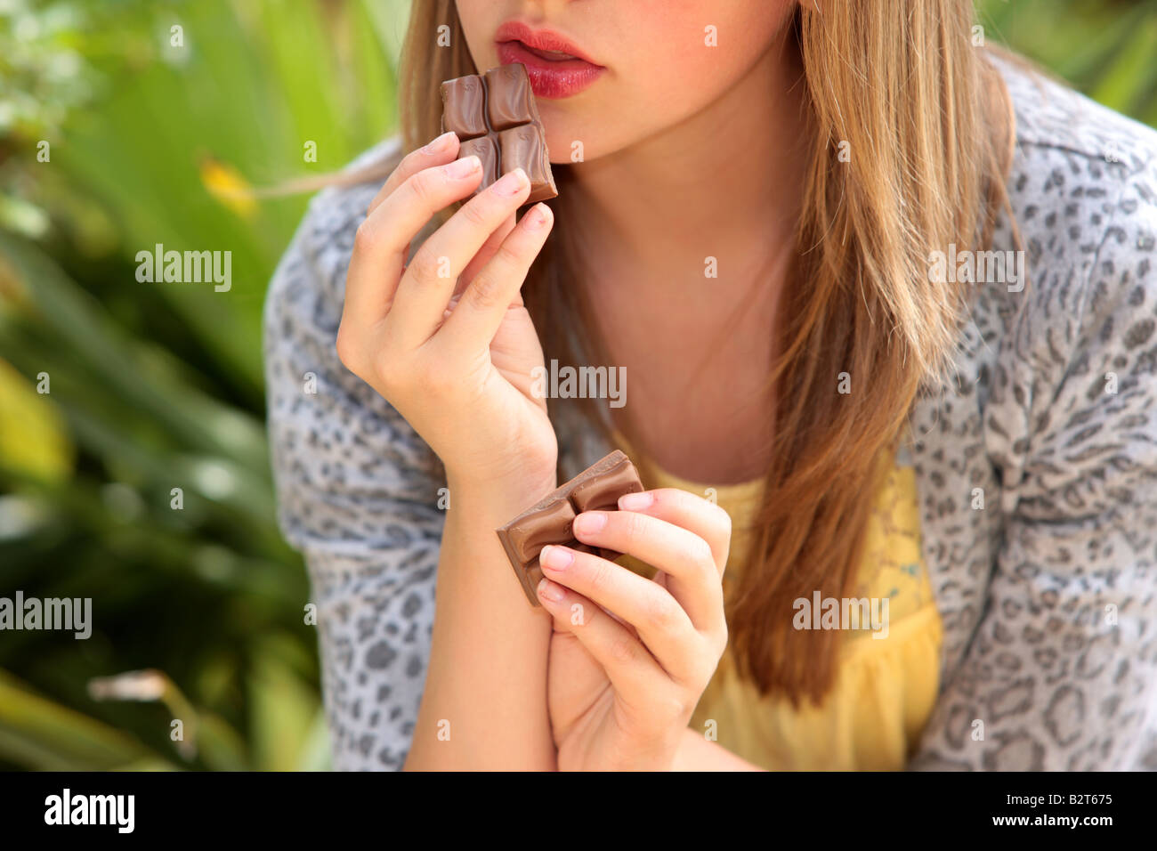 Teenage Girl Eating Bar of Chocolate Model Released Stock Photo - Alamy
