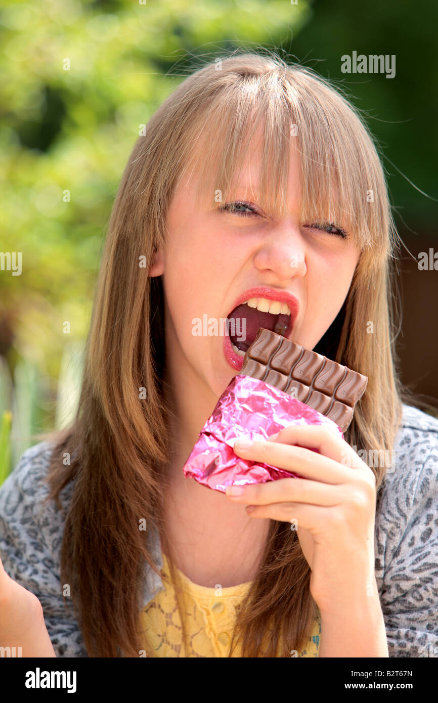 Teenage Girl Eating Bar of Chocolate Model Released Stock Photo - Alamy