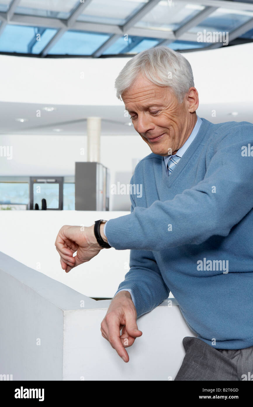 Man leaning against balustrade Stock Photo - Alamy