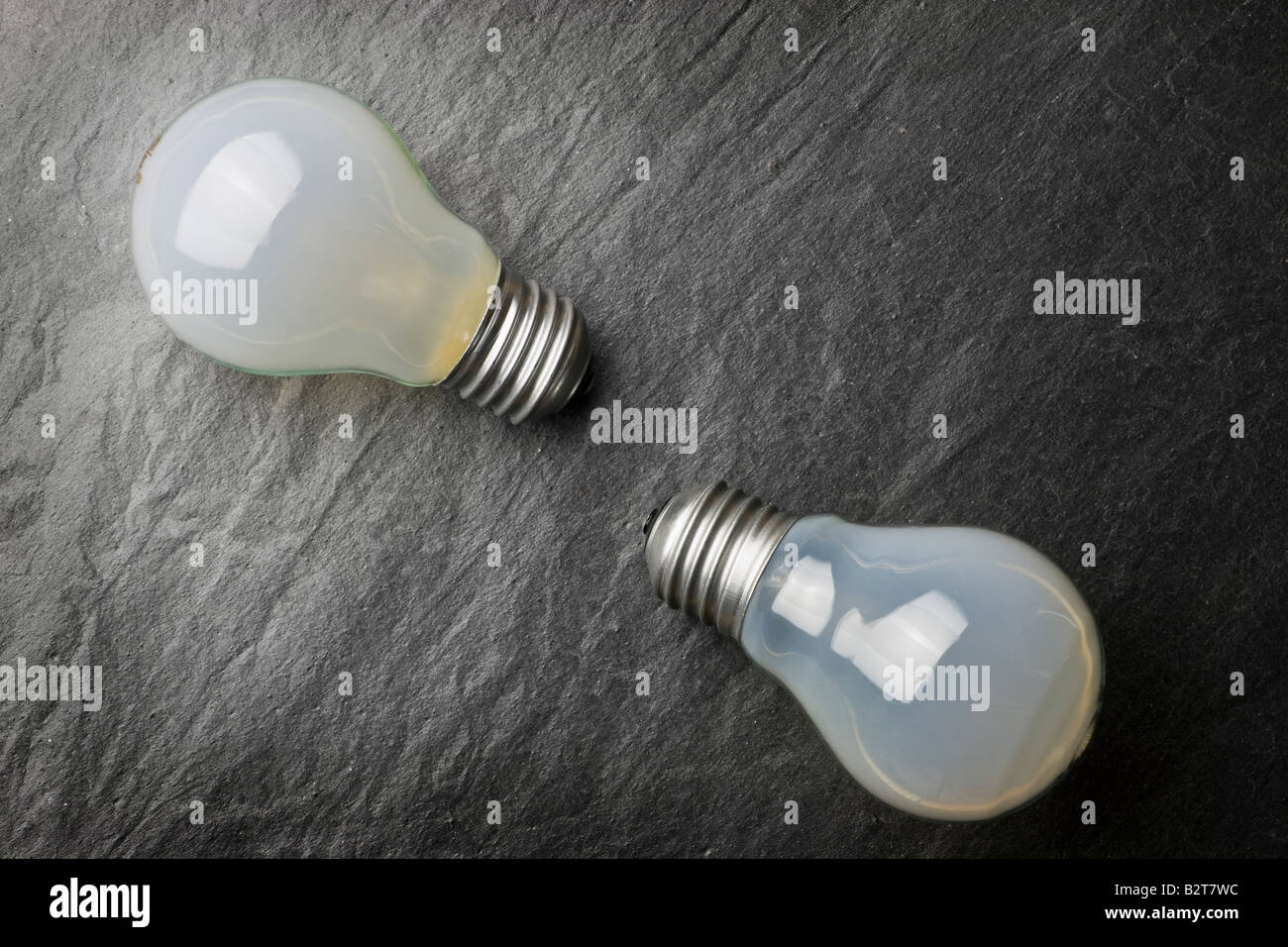 Two light bulbs on a grey background Stock Photo - Alamy