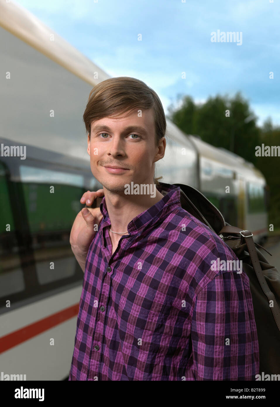 Young man on train station Stock Photo - Alamy