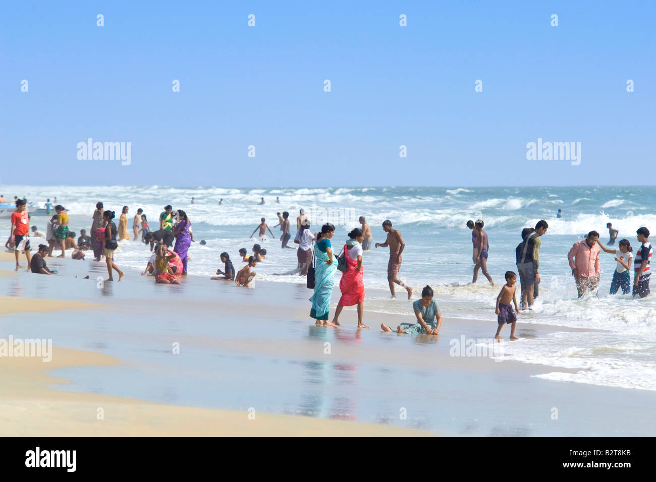 Local Indians enjoying a holiday at the beach on a hot sunny day in Goa ...