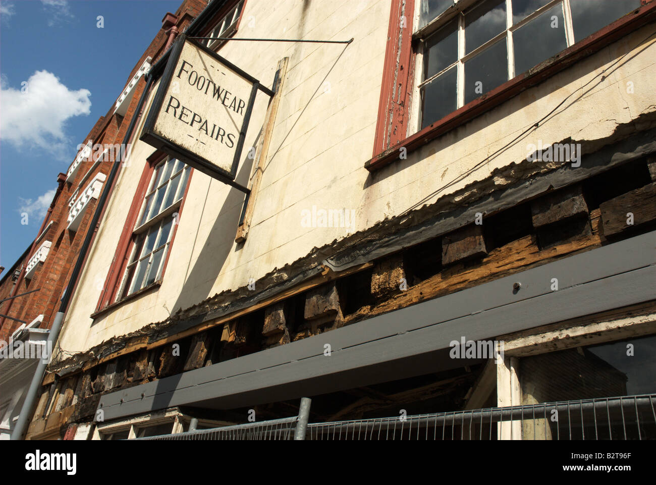 A decaying timber framed building being preserved/renovated by the ...