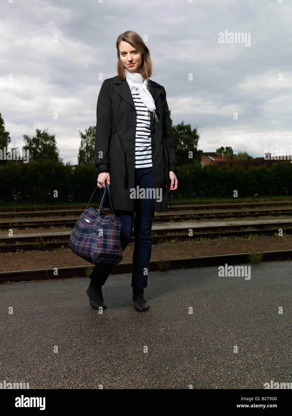 Woman on train station Stock Photo - Alamy
