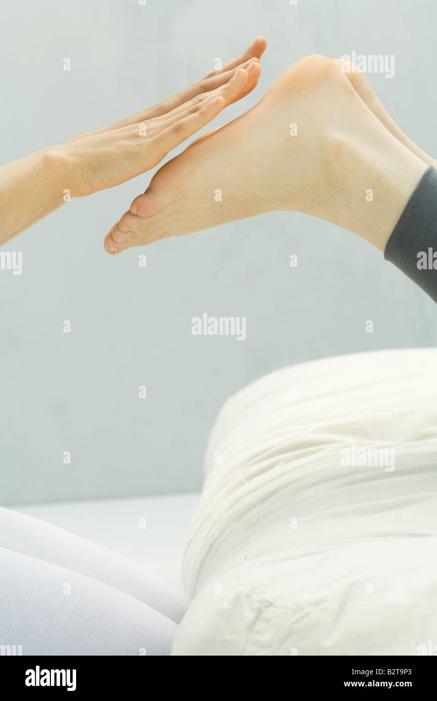 Person performing Reiki foot massage, cropped view Stock Photo - Alamy