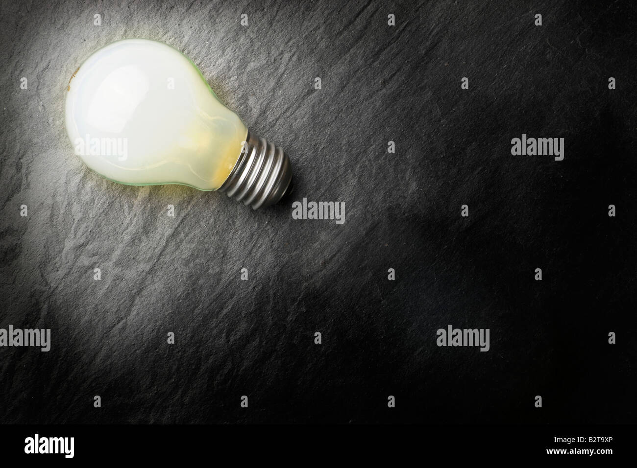 Light bulb on a grey background Stock Photo - Alamy
