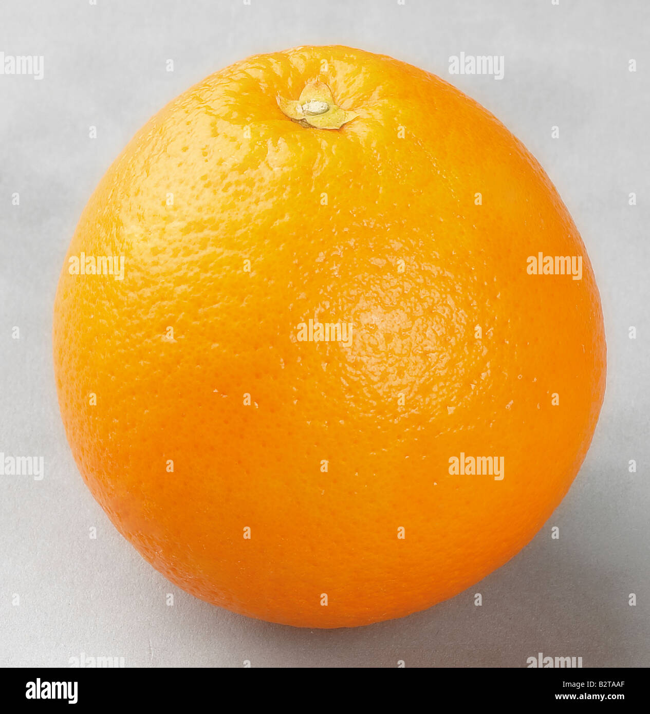 whole orange sat on paper Stock Photo - Alamy