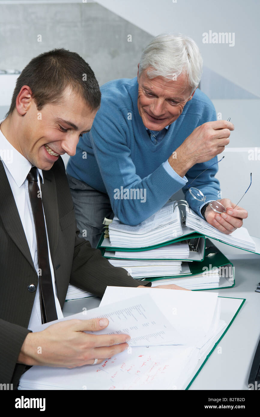 Colleagues looking at document Stock Photo - Alamy