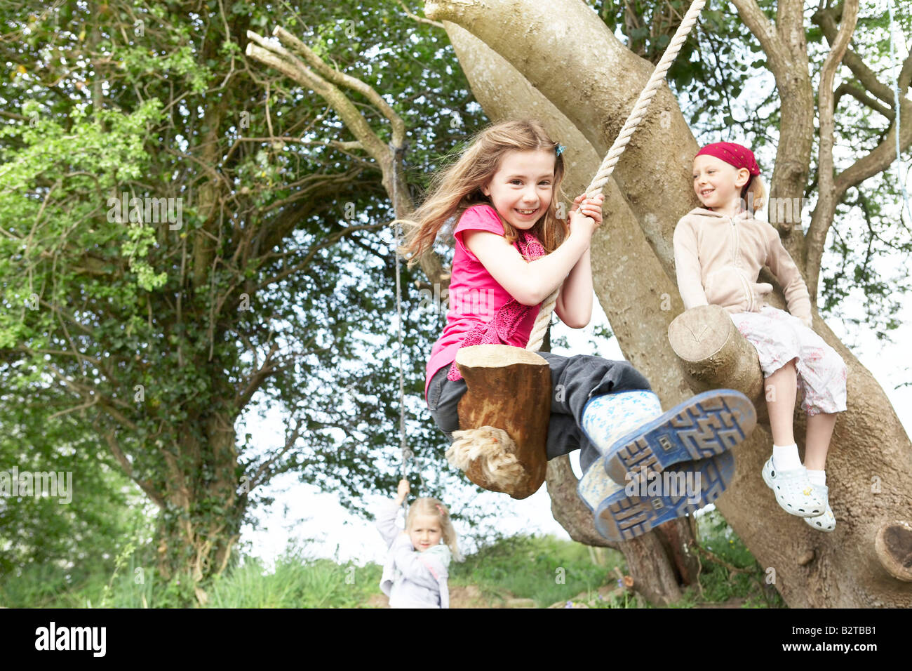Young girl on rope swing Stock Photo - Alamy