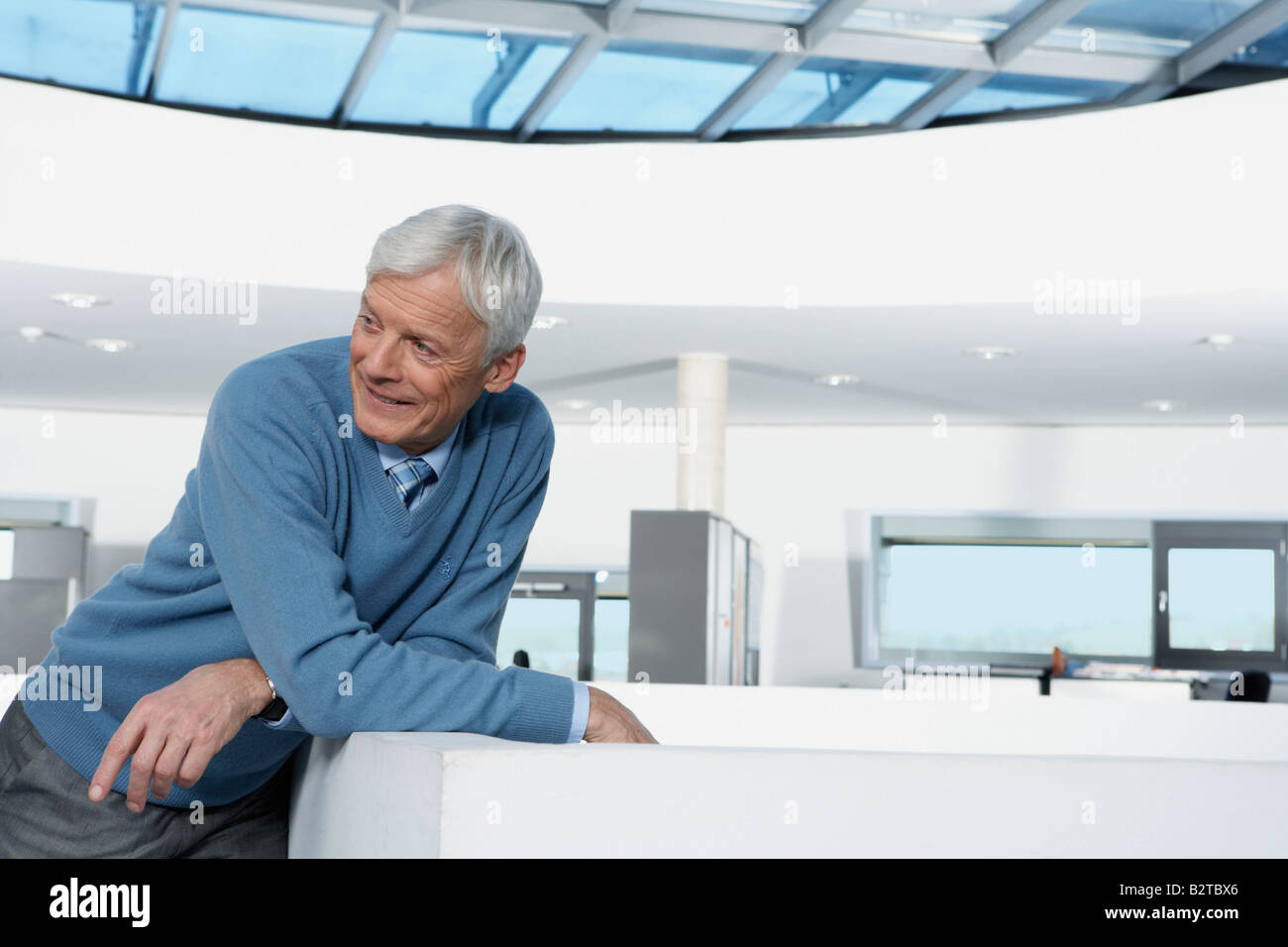 Man leaning against balustrade Stock Photo - Alamy
