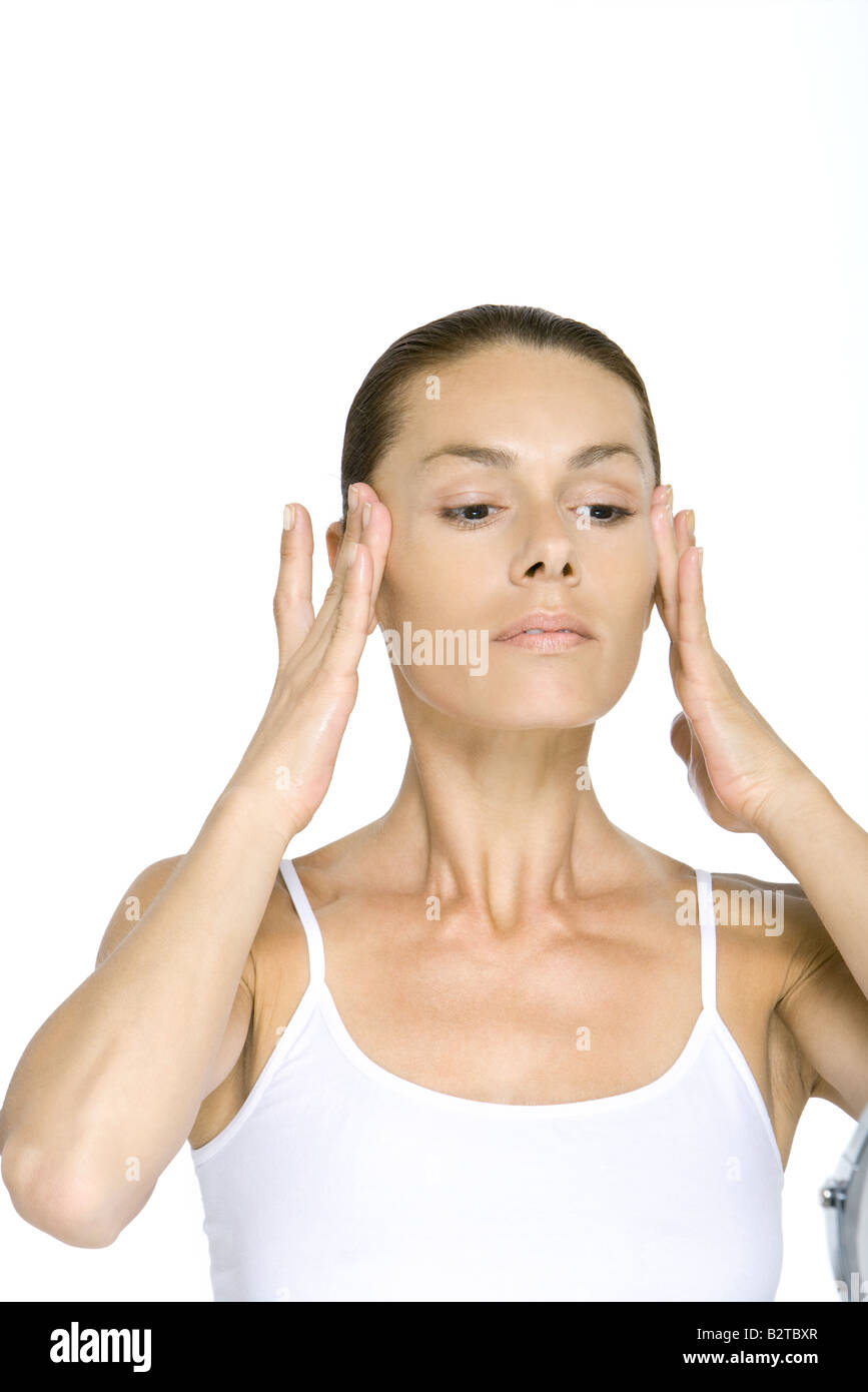 Woman touching face, pulling back cheeks Stock Photo - Alamy