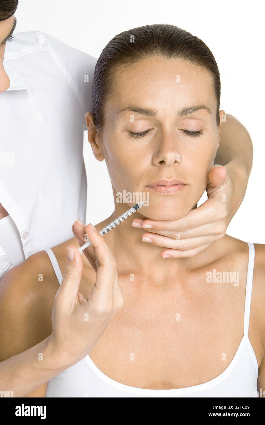 Woman receiving collagen injection, eyes closed Stock Photo - Alamy