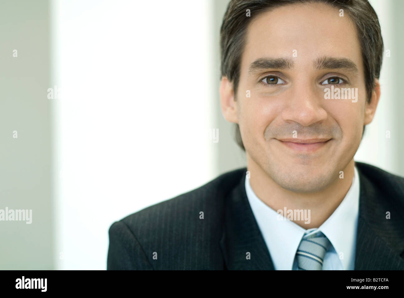 Businessman smiling at camera, portrait Stock Photo - Alamy