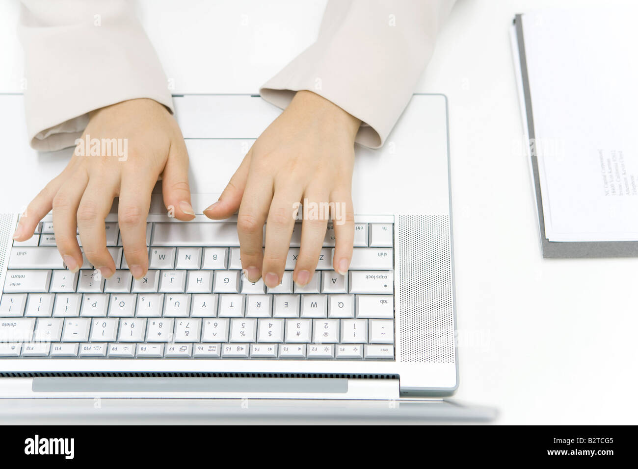 Person typing on laptop computer, cropped view of hands, overhead view ...