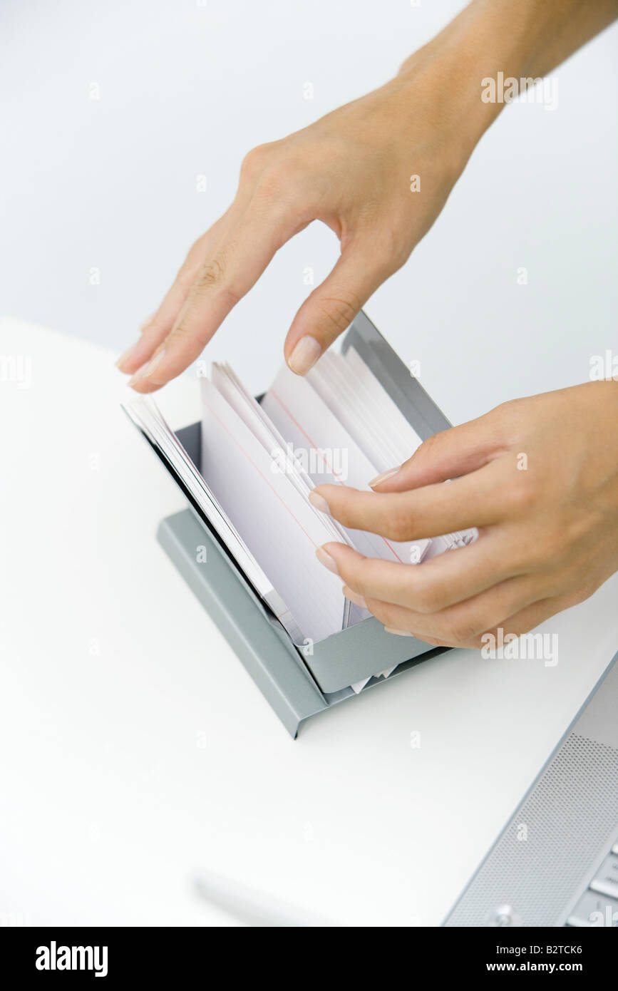 Hands flipping through card file, cropped view Stock Photo - Alamy