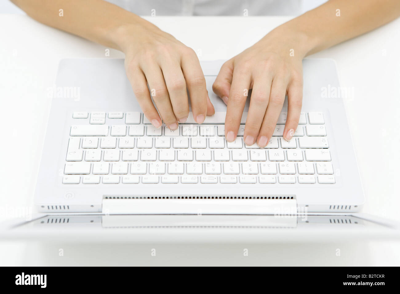 Person using laptop computer, cropped view of hands, overhead view ...