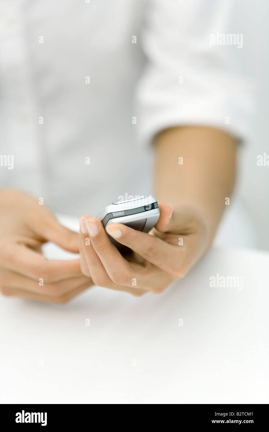 Person holding cell phone, cropped view of hands Stock Photo - Alamy