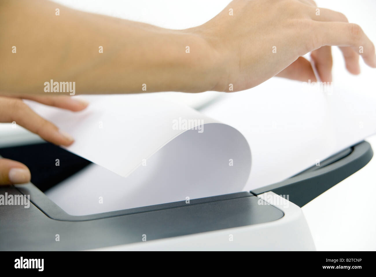 Hands arranging paper in printer, cropped Stock Photo - Alamy