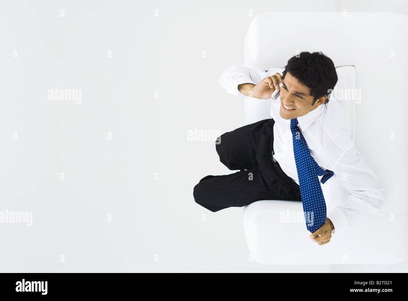 Hispanic man tugging tie on hi-res stock photography and images - Alamy