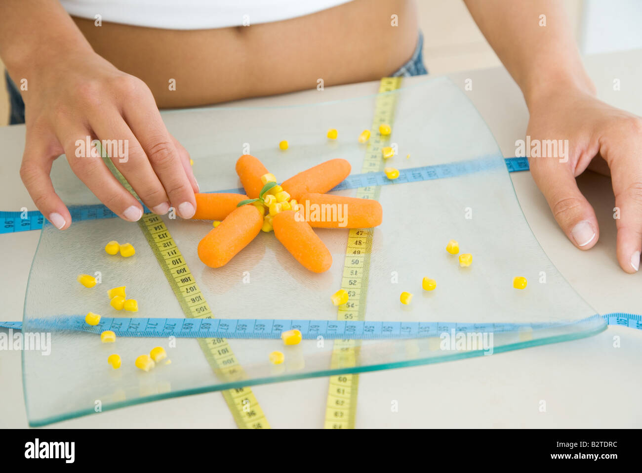 Woman arranging raw vegetables and measuring tapes, cropped view Stock ...