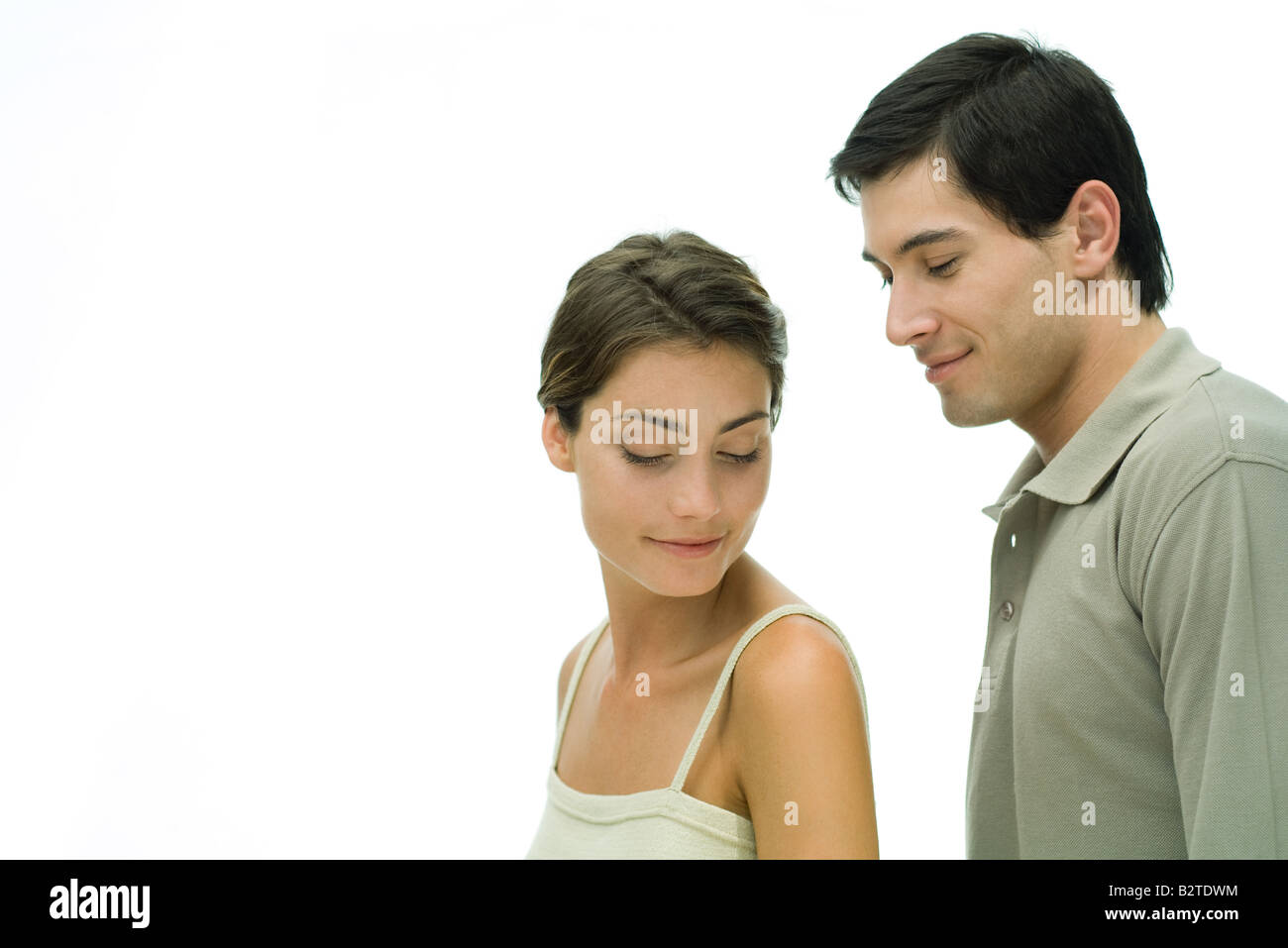 Young couple with eyes closed, man standing behind woman, portrait ...