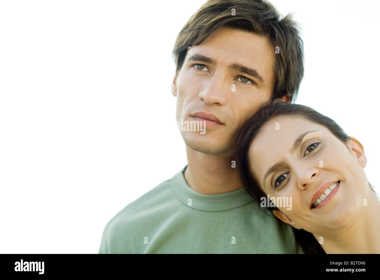 Woman leaning head against man's shoulder, smiling at camera Stock ...