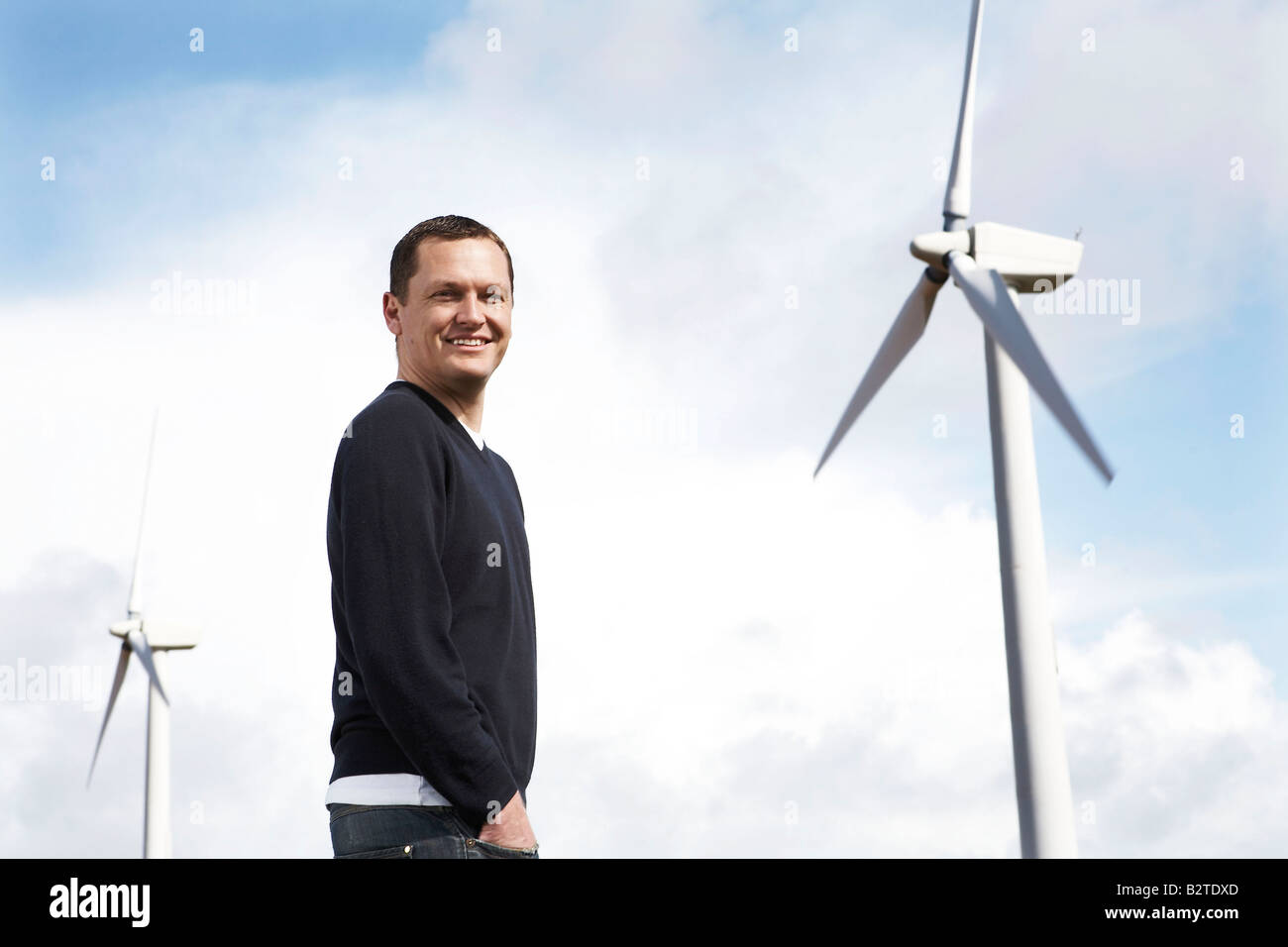 Man on wind farm Stock Photo - Alamy