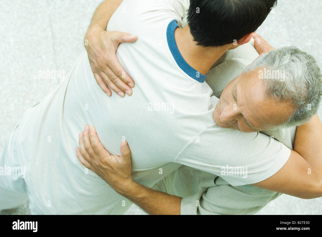 Two men hugging, high angle view Stock Photo - Alamy