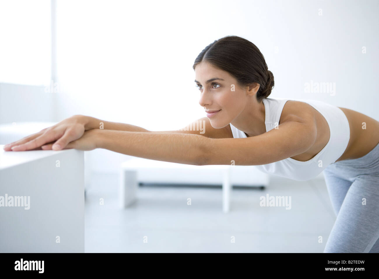 Woman stretching, bending over, arms outstretched Stock Photo - Alamy