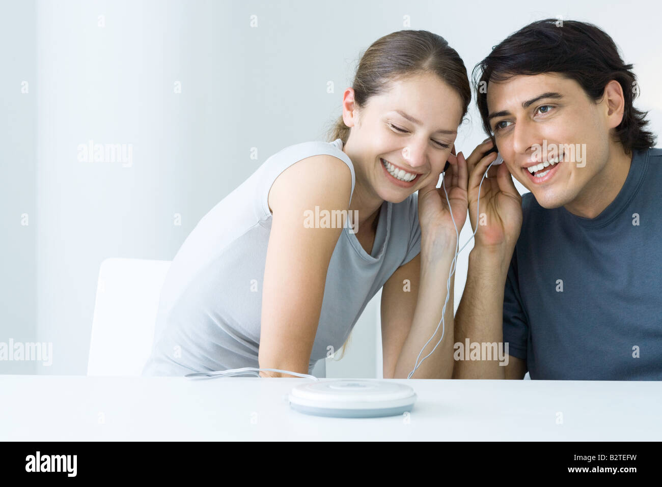 Couple sharing earbuds hi-res stock photography and images - Alamy