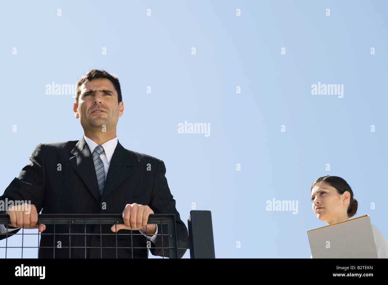 Businessman gripping railing looking in hi-res stock photography and ... Businessman gripping railing looking in hi-res stock photography and ...