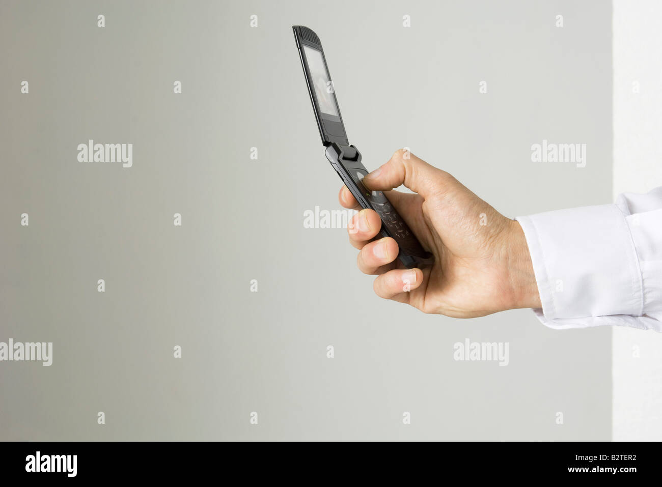 Hand holding cell phone, side view Stock Photo - Alamy