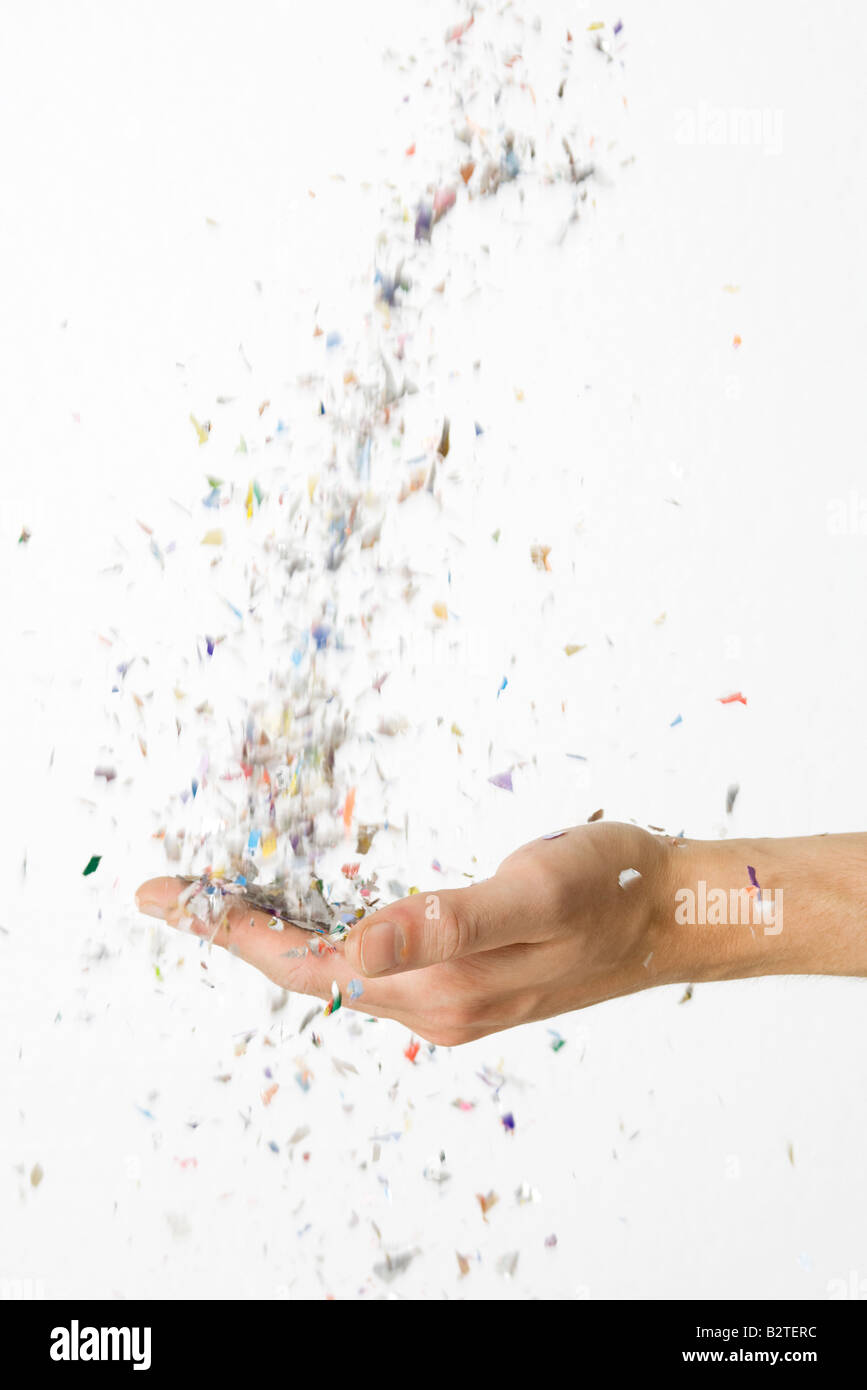 Hand catching falling confetti Stock Photo - Alamy