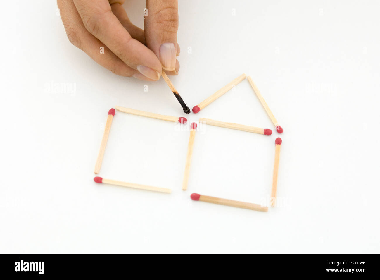 Hand arranging matches, holding one burnt match Stock Photo - Alamy