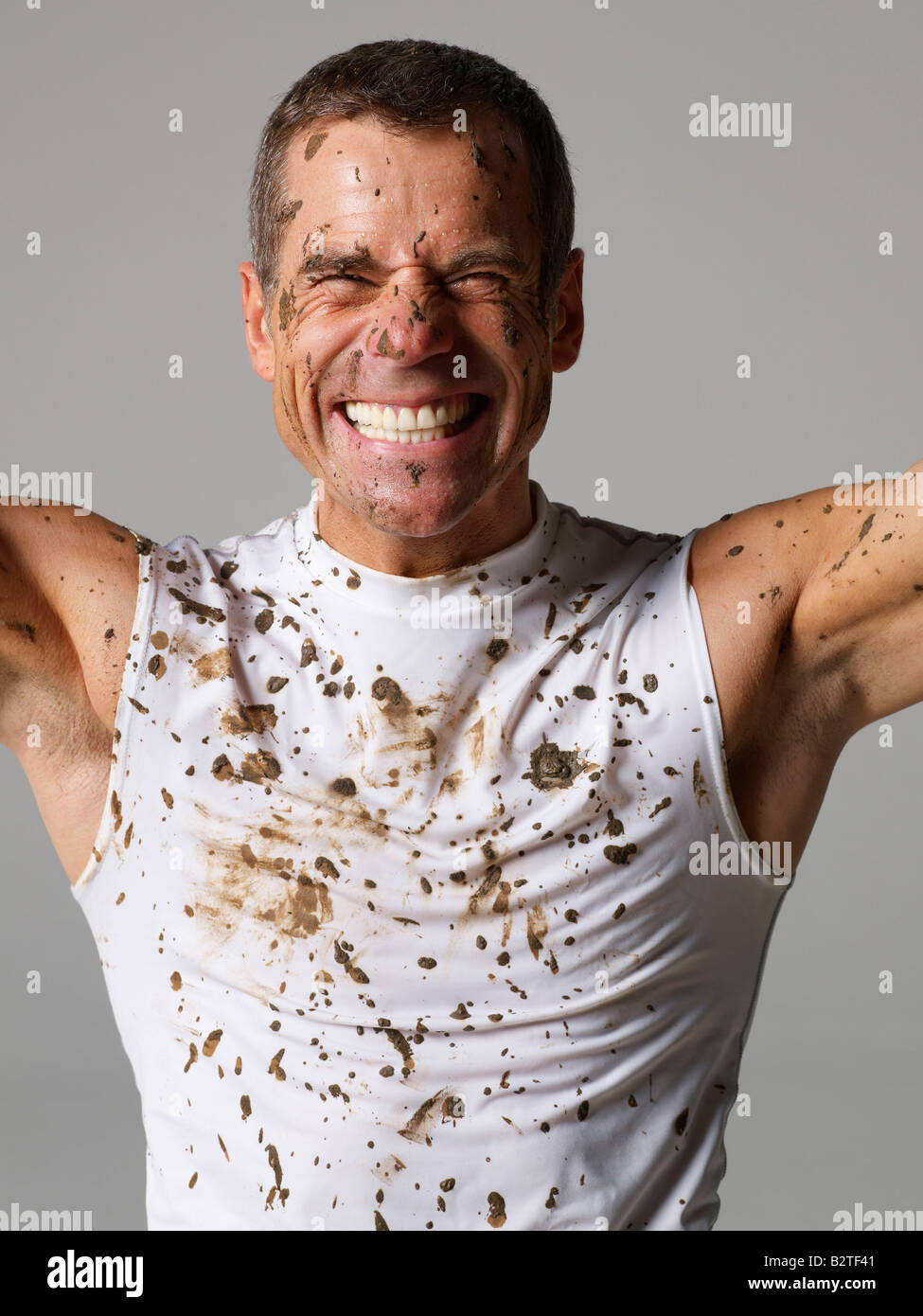 Joyous mud covered man Stock Photo - Alamy